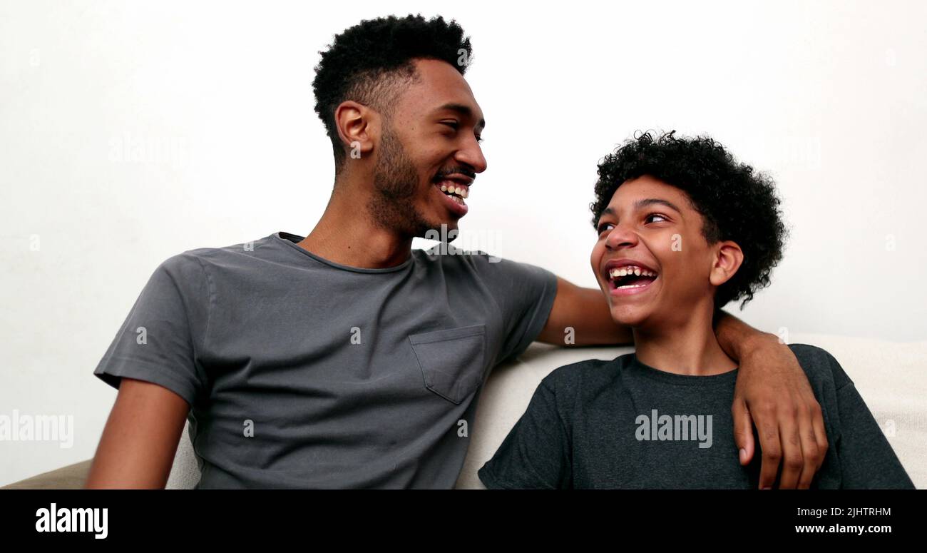 Two brothers relationship laughing and smiling together. Older and ...
