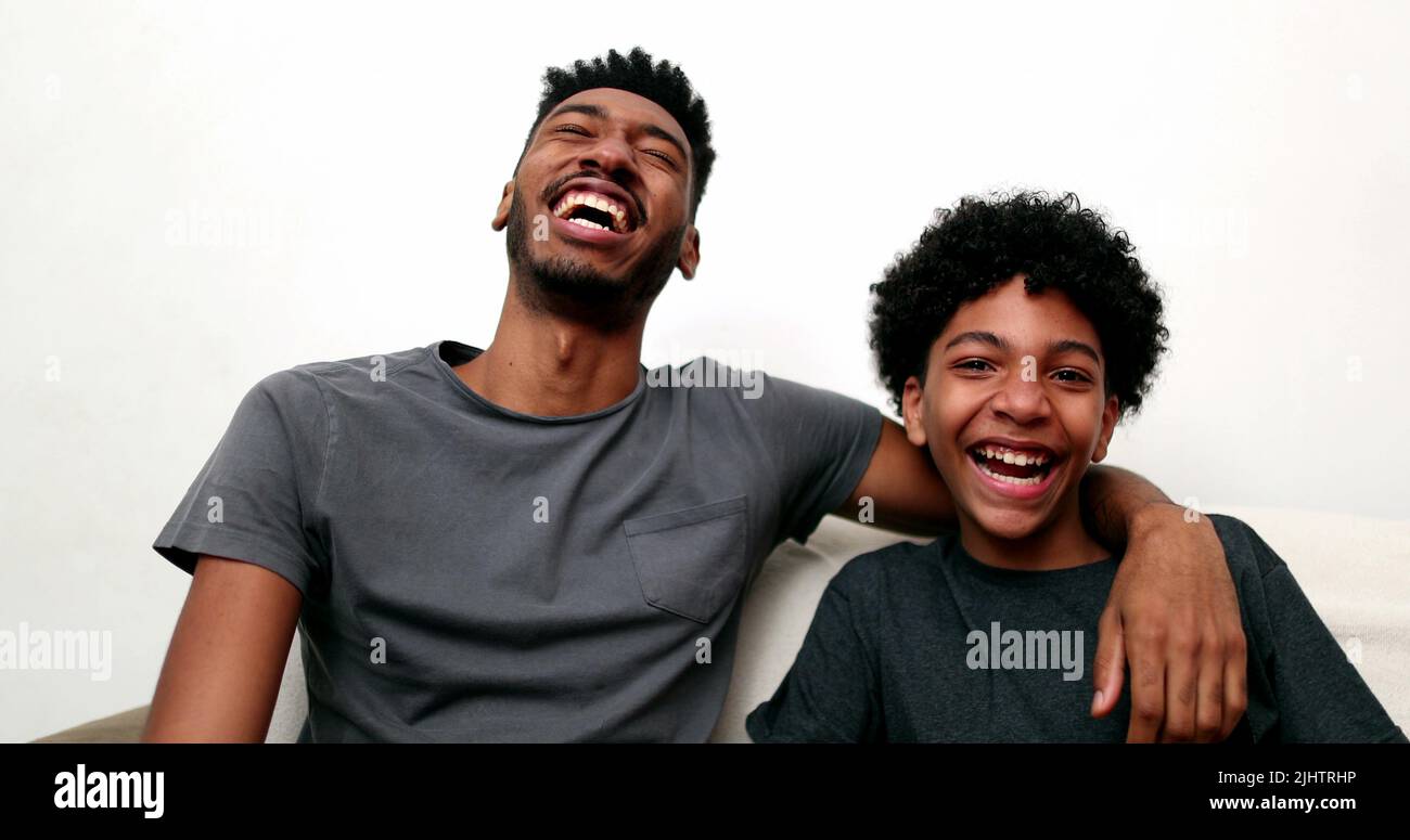 Two brothers relationship laughing and smiling together. Older and ...