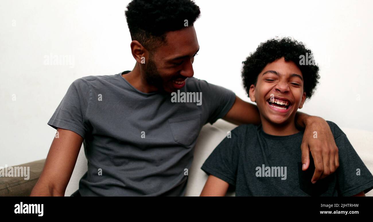 Two brothers talking together sitting hi-res stock photography and ...