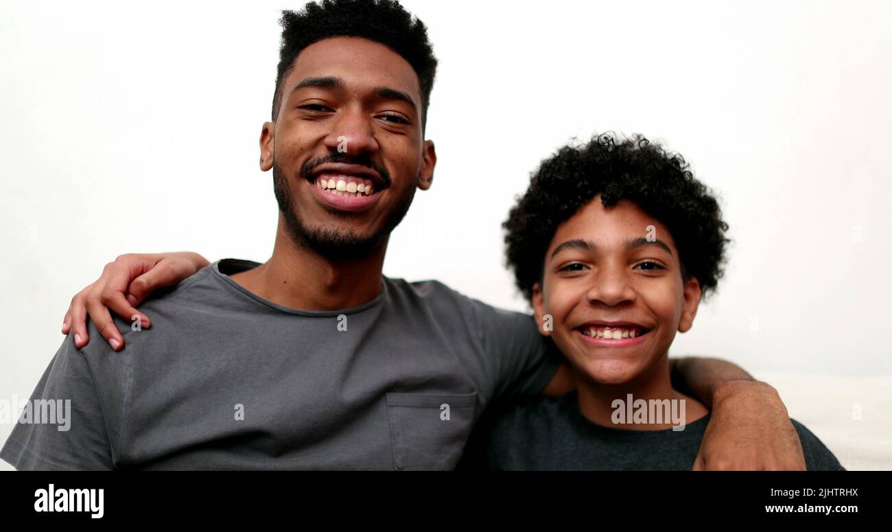 Two brothers relationship laughing and smiling together. Older and ...