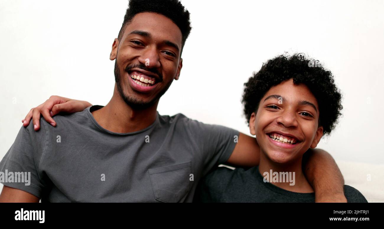 Two brothers relationship laughing and smiling together. Older and ...