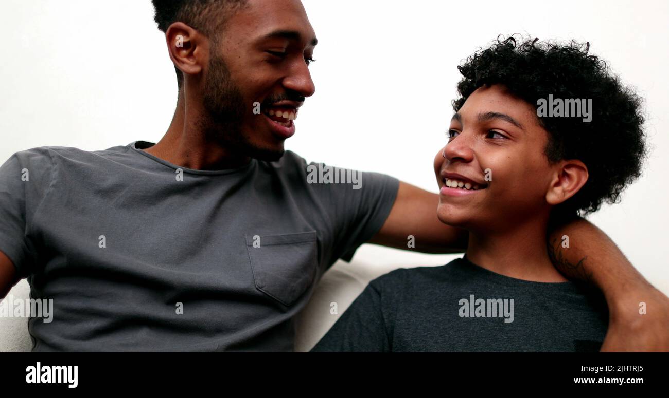 Two brothers relationship laughing and smiling together. Older and ...