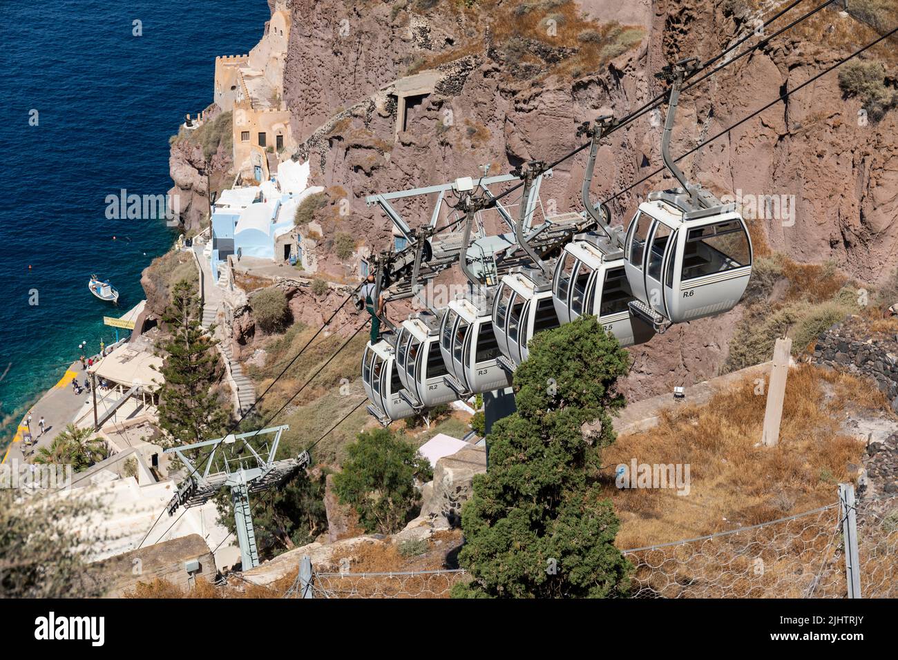 Man on top of a cable car repairing the line. The Cable car runs from ...