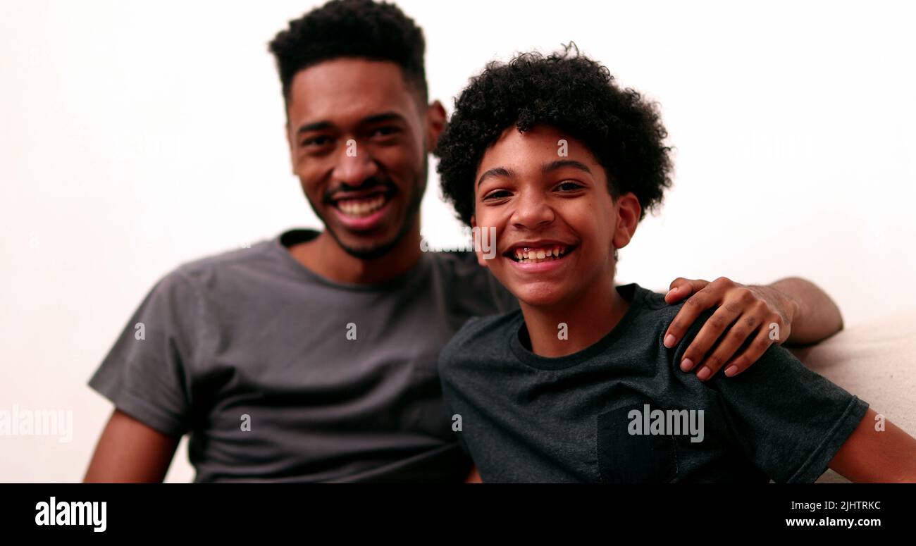 Two brothers together smiling. Black mixed race siblings, older and ...