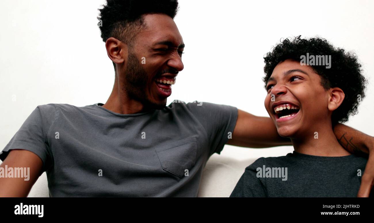 Two brothers relationship laughing and smiling together. Older and ...