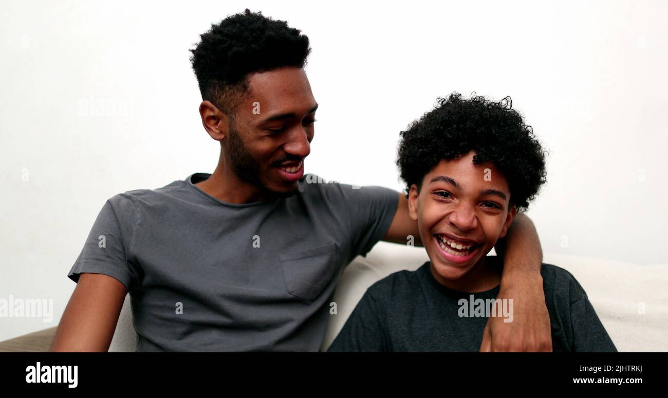 Two brothers relationship laughing and smiling together. Older and ...