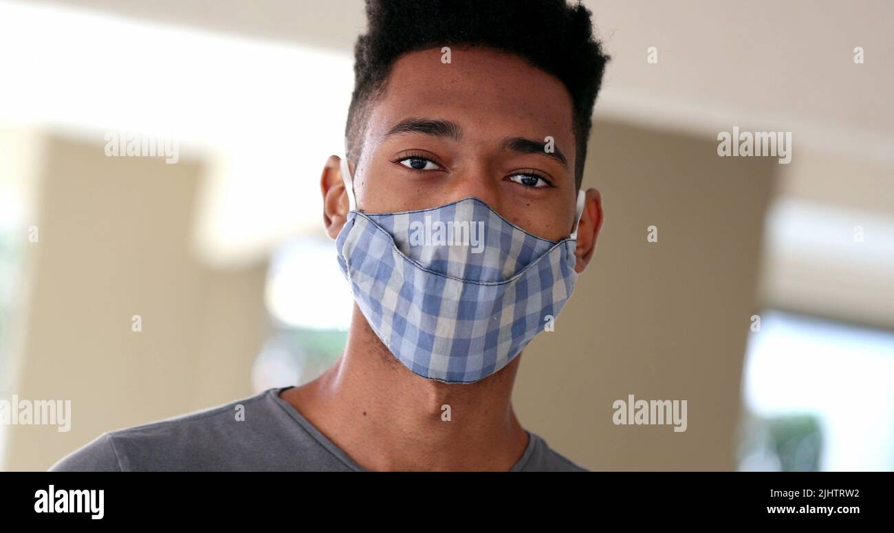 Young African man wearing covid-19 face mask, mixed race ethnicity ...