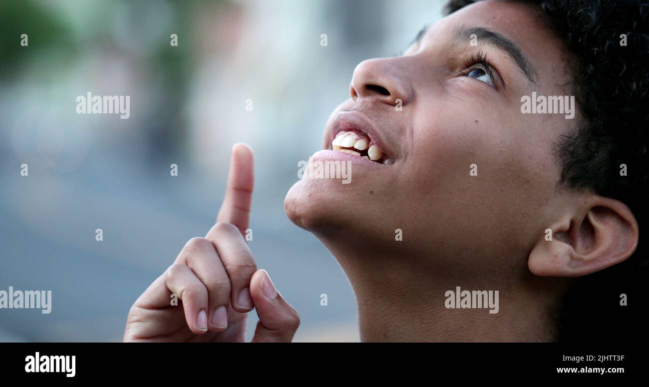 Young boy praying to God. Religious Mixed race child looking at sky ...