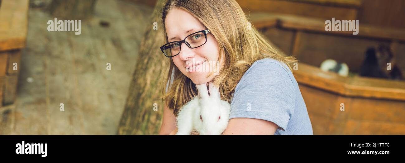 Happy woman with white baby rabbit. Smiling Girl with little Easter ...