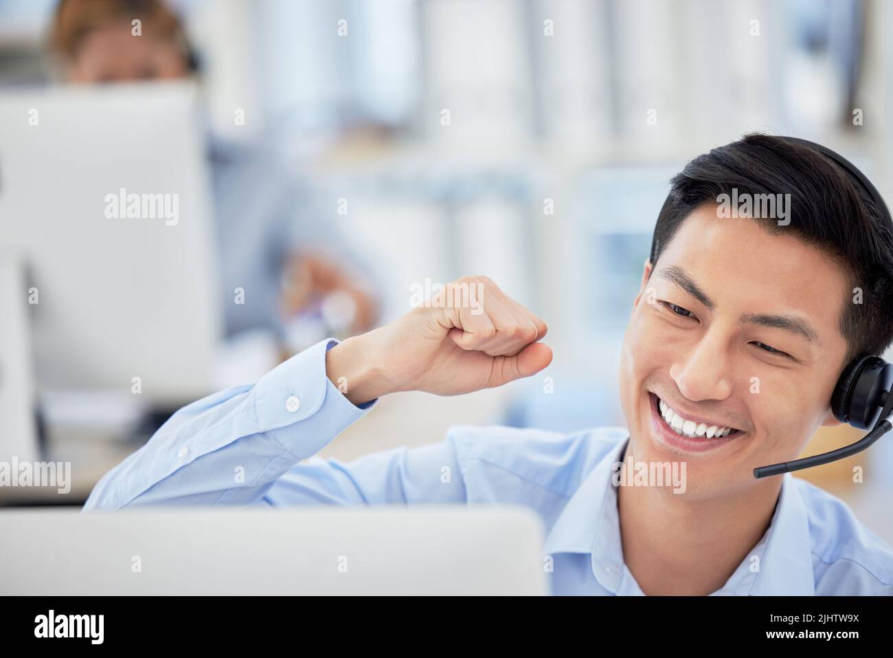 Excited asian businessman celebrating a success cheering and punching ...