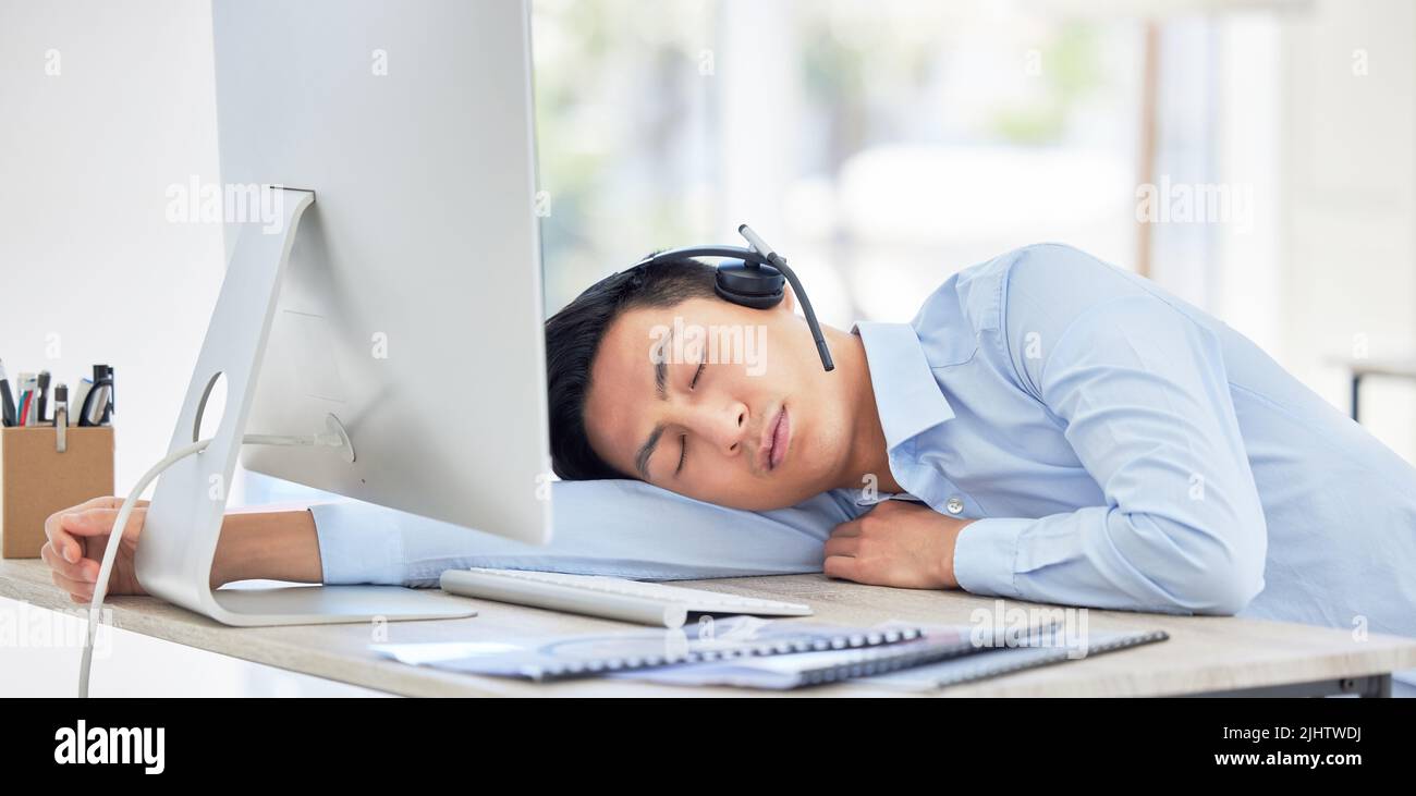 Close up of young asian businessman feeling tired and sleeping on the ...