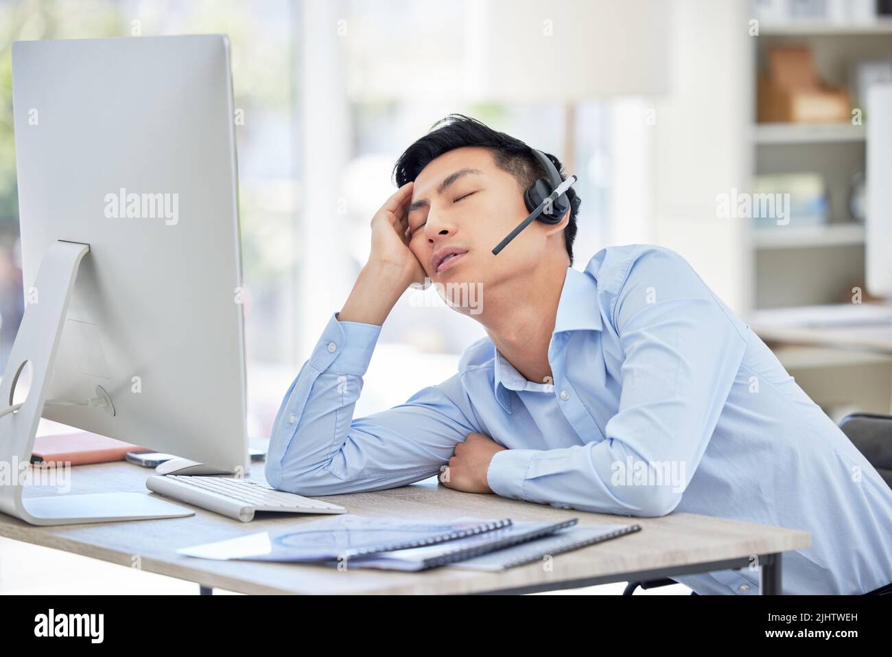 Close up of young asian businessman feeling tired and sleeping on the ...