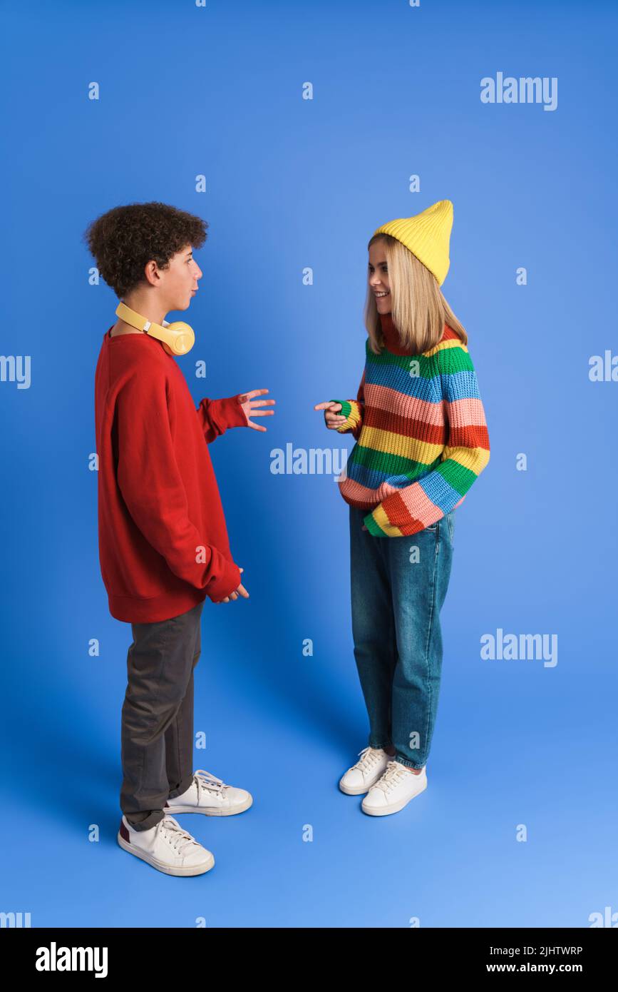 White girl and boy smiling and gesturing while talking isolated over ...
