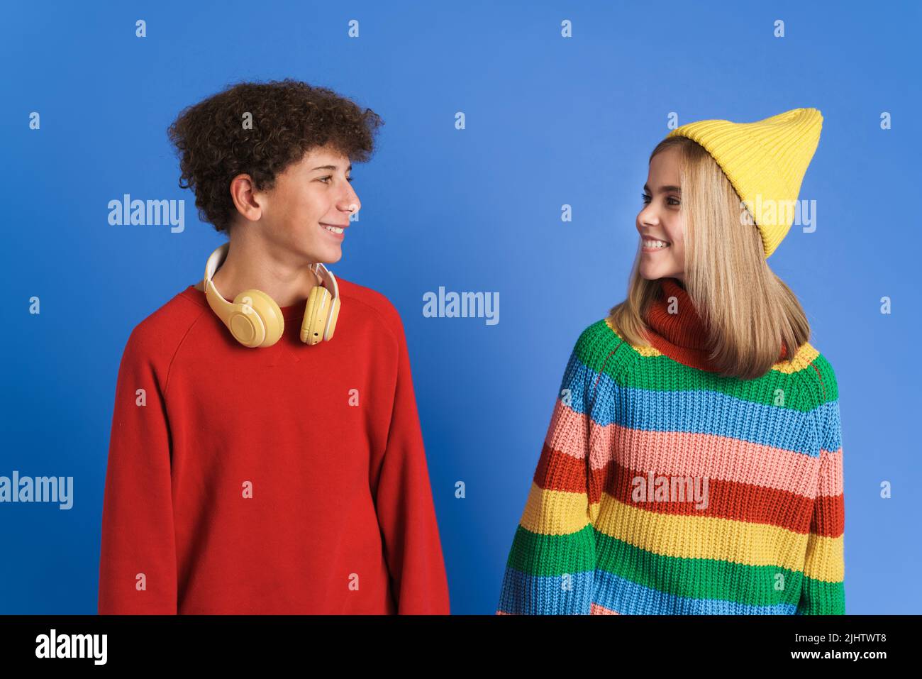 White two teenagers smiling at each other while posing together ...