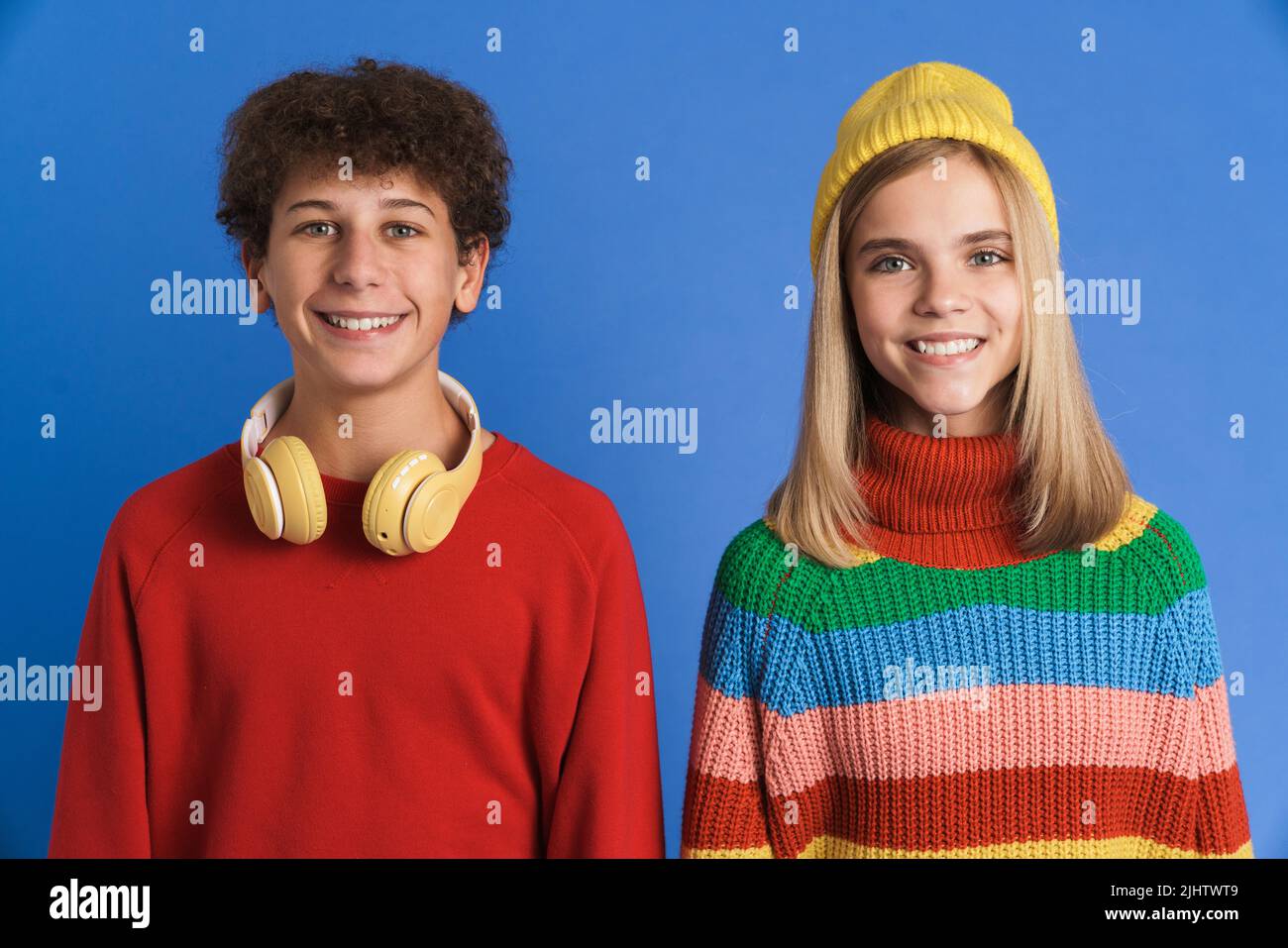 White two teenagers smiling at camera while posing together isolated ...