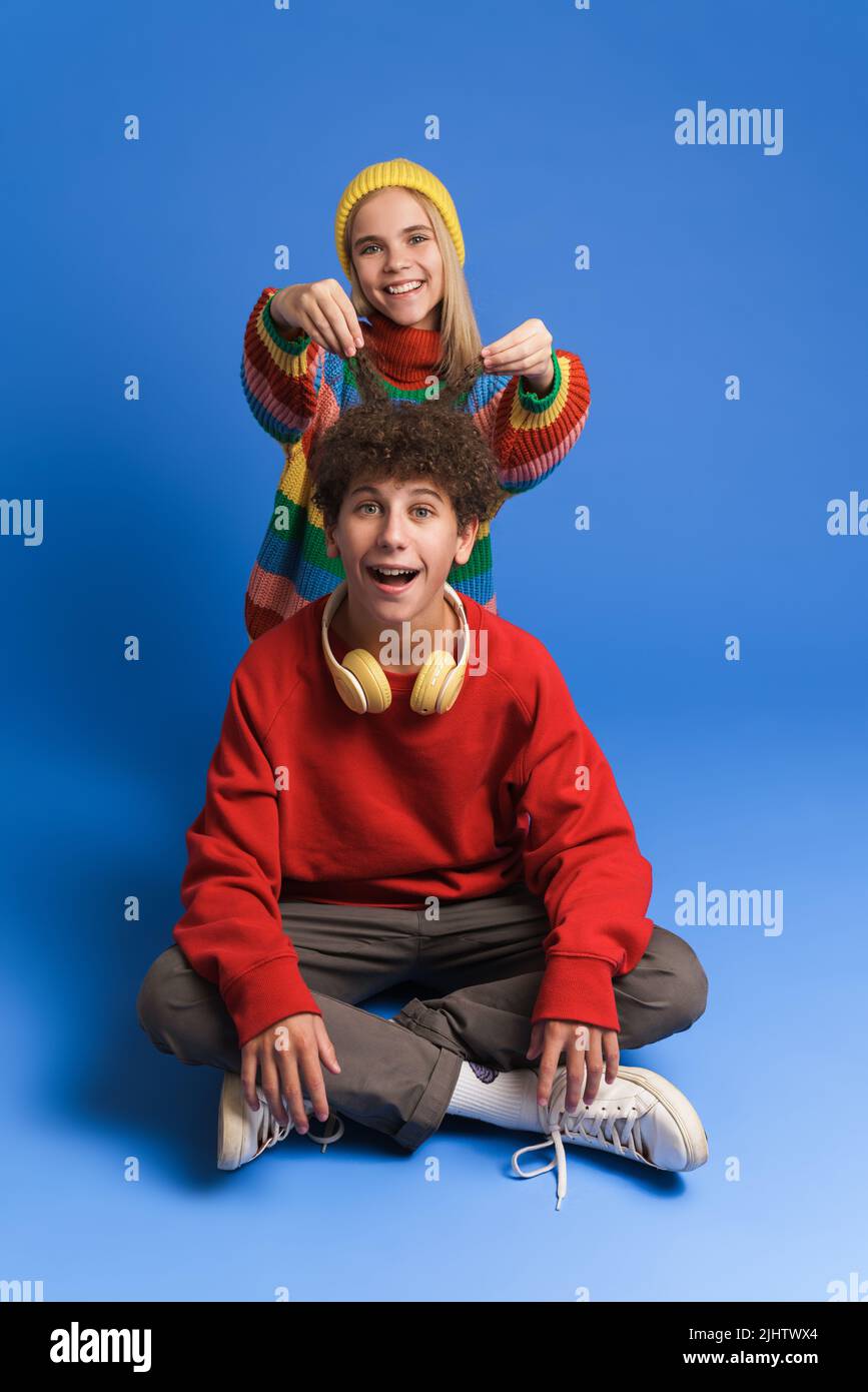 White girl and boy laughing while making fun together isolated over ...