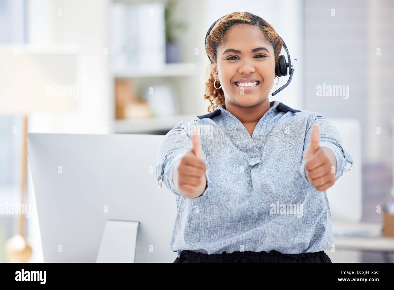 It support agent giving the thumbs up. Businesswoman working in ...