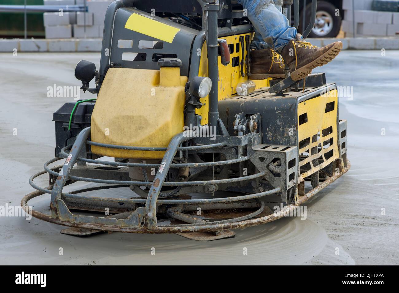 Workers are using concrete polishing machines for cement after pouring ...