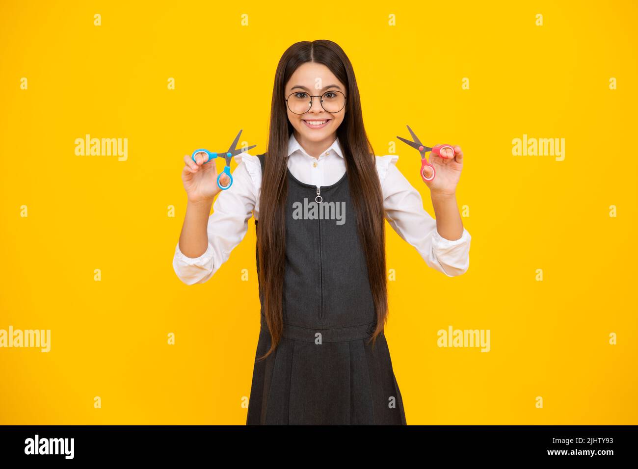 Teenage girl with scissors, isolated on yellow background. Child ...