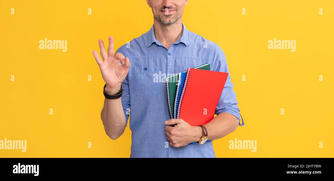 smiling man hold school notebook or planner show ok gesture, school ...