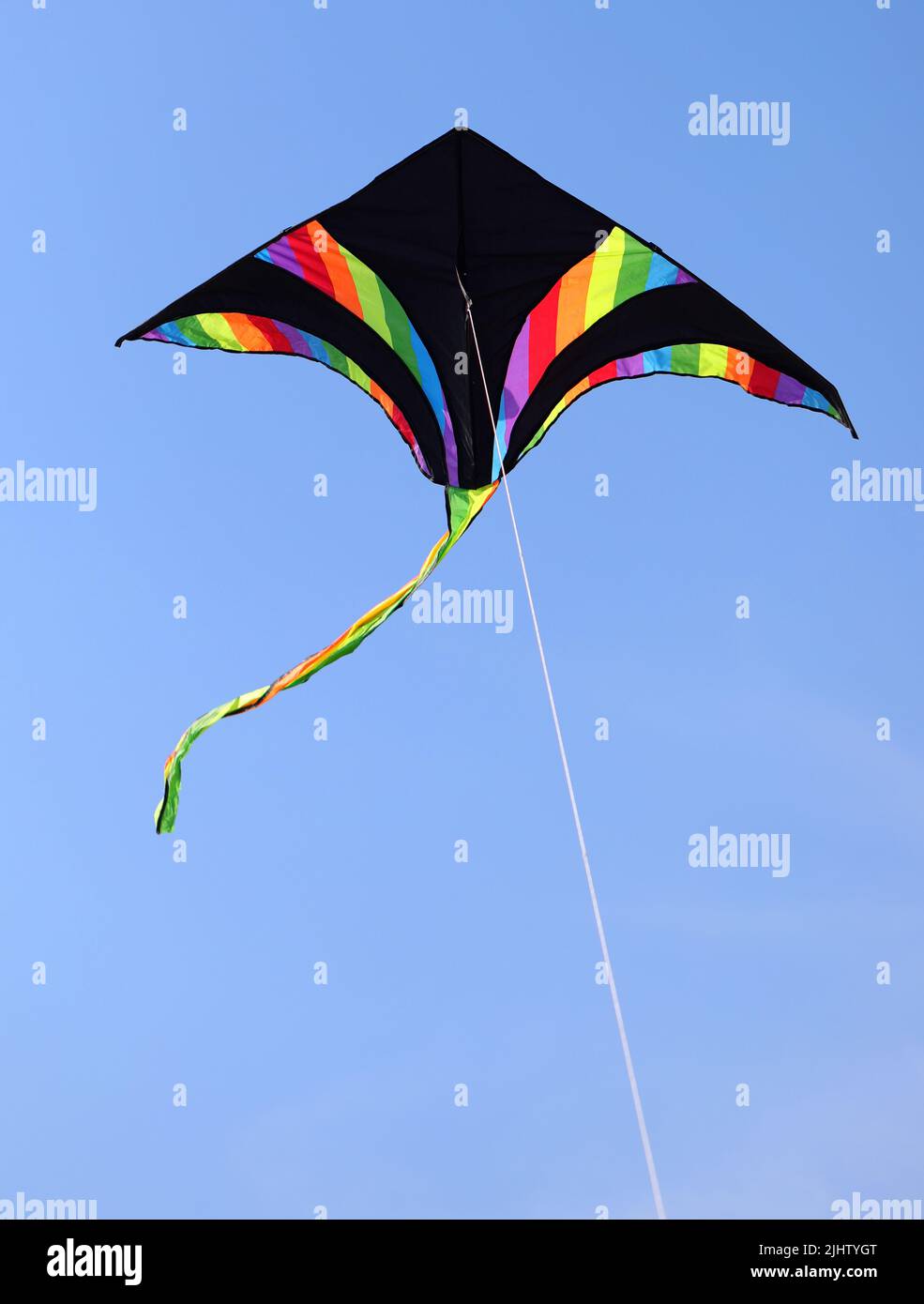 triangular-shaped kite in black and with multicolored bands that wants ...