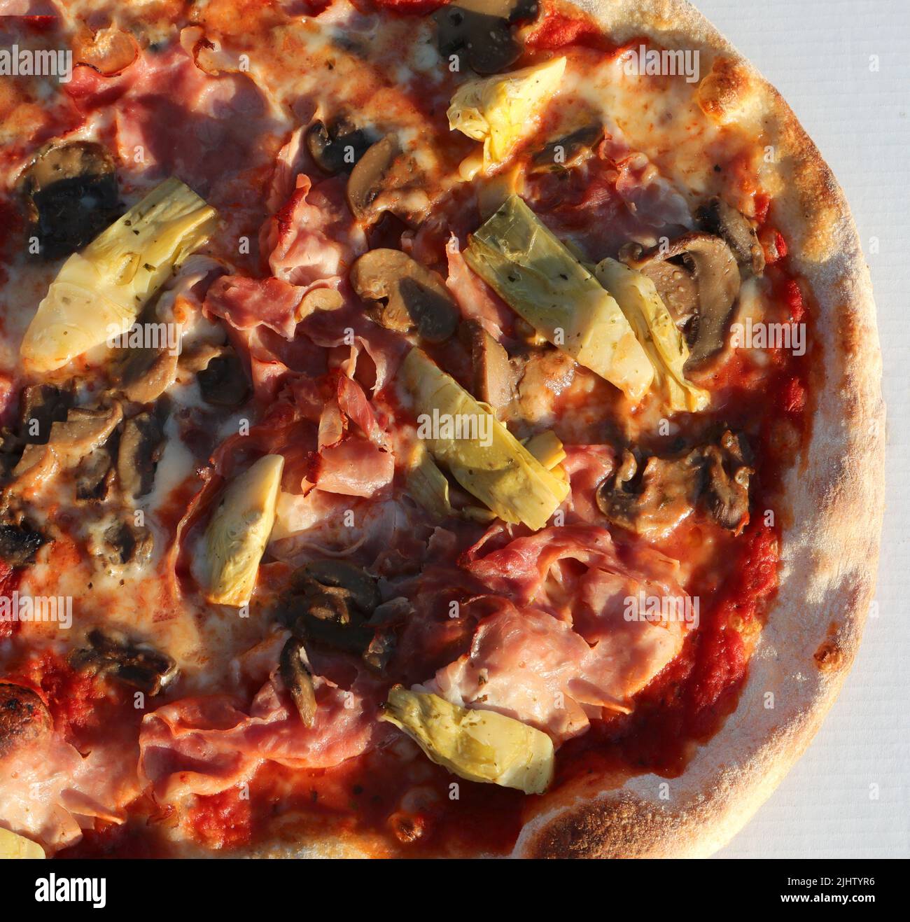 pizza called in Italy of the capricciosa type with mushrooms cooked ham ...