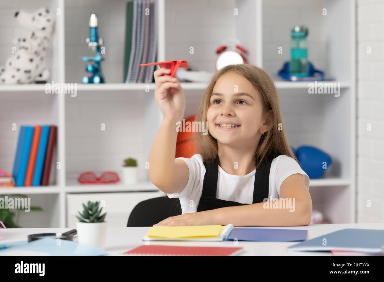 positive child play with paper plane in school classroom Stock Photo ...