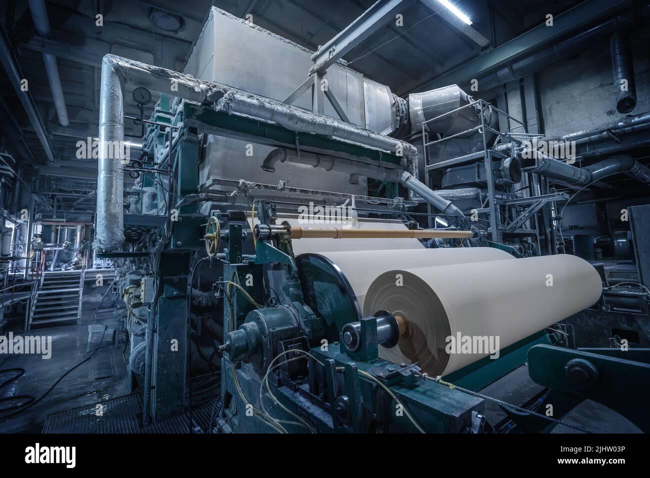 Paper production machine in wastepaper recycling factory. Paper and ...