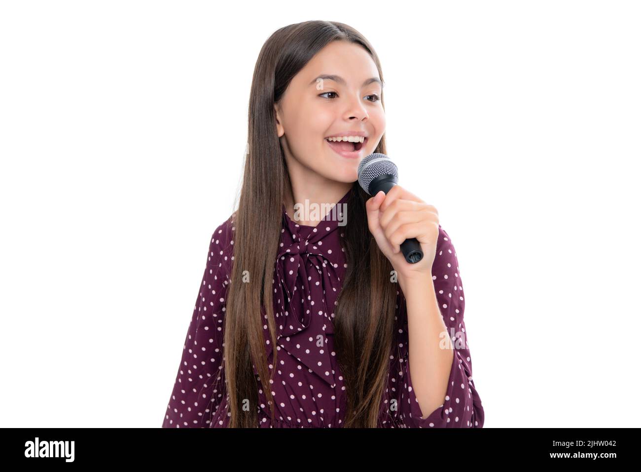 Kid singing. Emotional amazed teen girl with microphone singing against ...