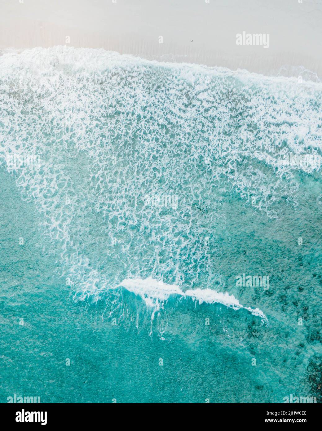 Aerial view of waves breaking on secluded beach hi-res stock ...