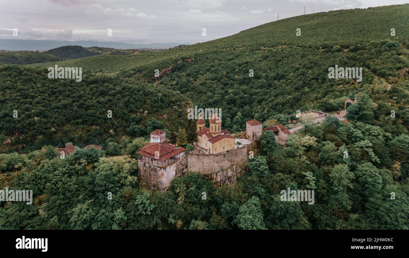 An aerial view of Motsameta Monastery surrounded by dense trees in ...