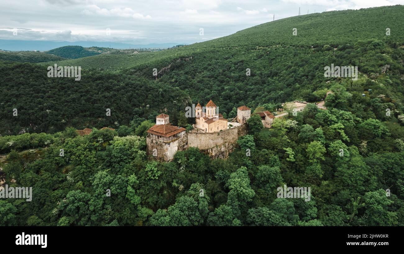 An aerial view of Motsameta Monastery surrounded by dense forest in ...
