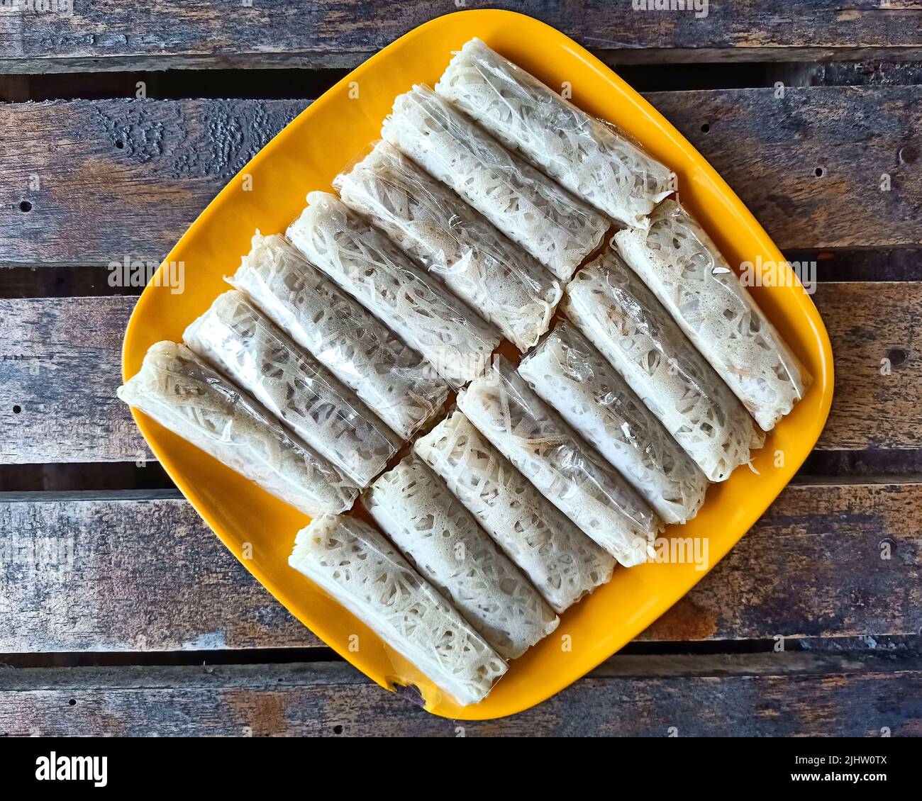A shot of the Roti Jala on an orange plate Stock Photo - Alamy