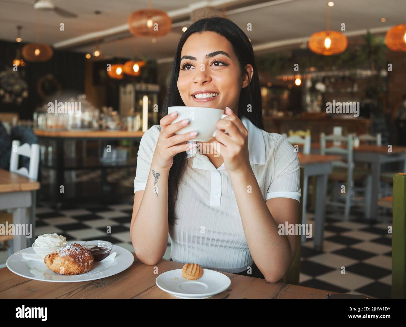 Feeding her body what it wants. a young woman enjoying a cup of coffee ...