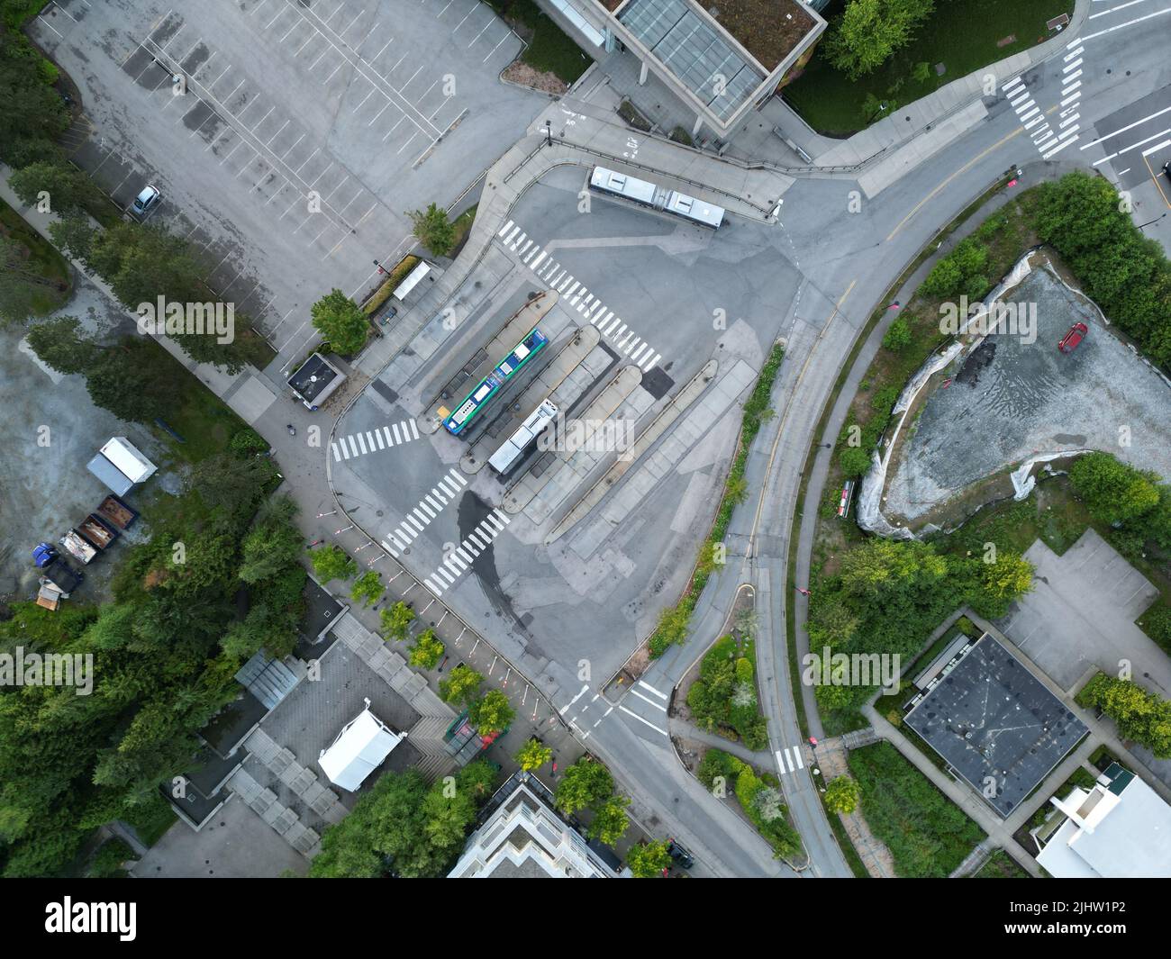 A high-angle shot of a confusing urban street with buildings a parking ...