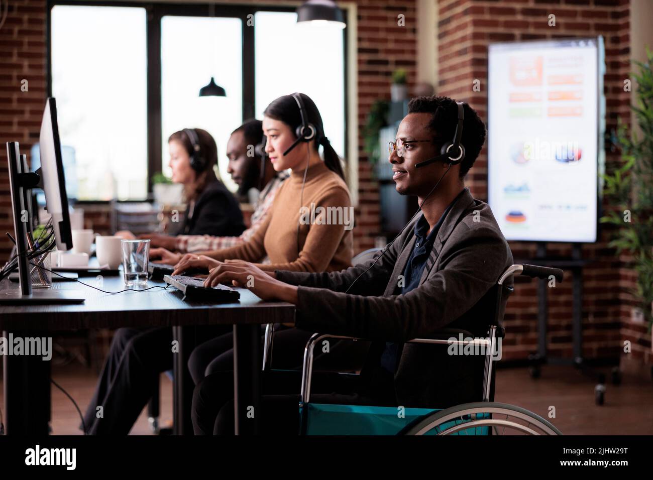 African american call center operator living with disability and using ...