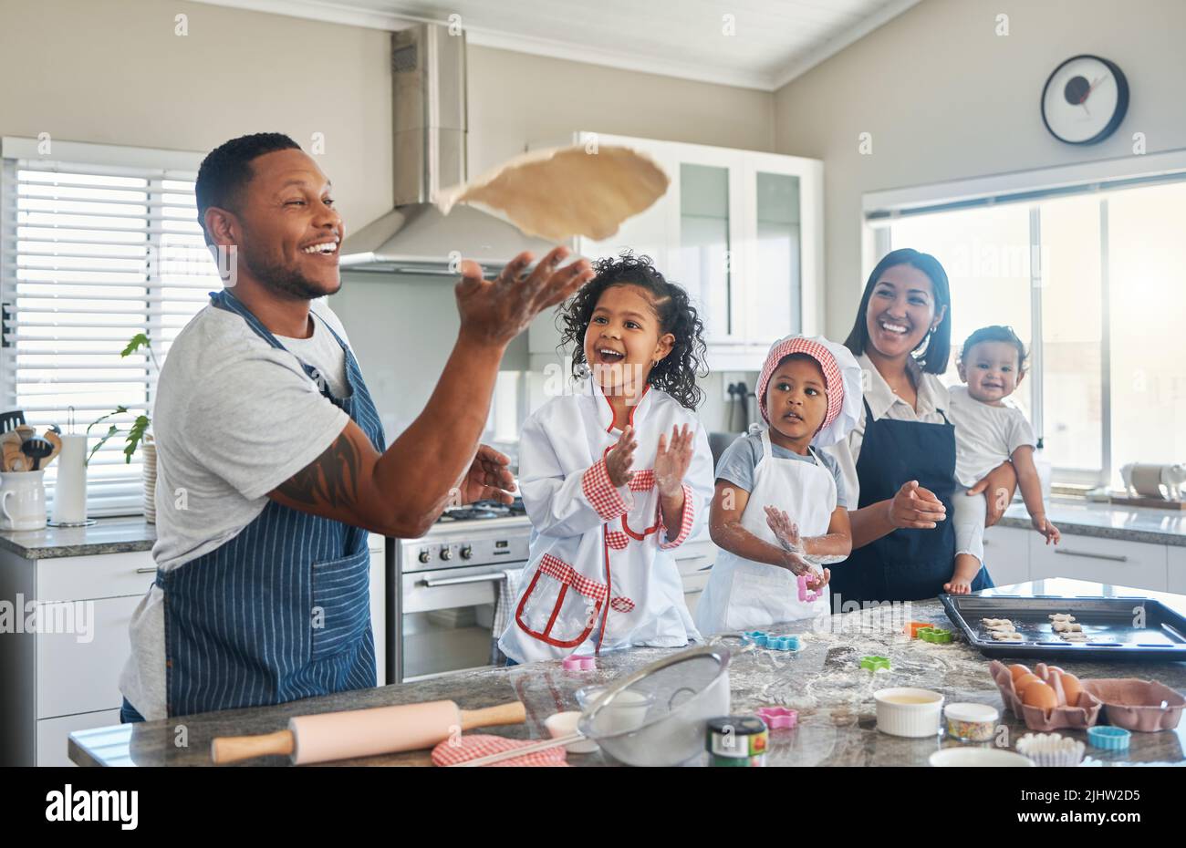 I enjoy cooking with my family. a couple baking at home with their ...