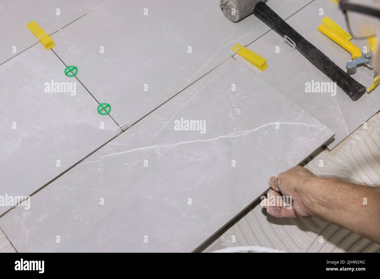 The application of tile adhesive to the floor during the process of ...