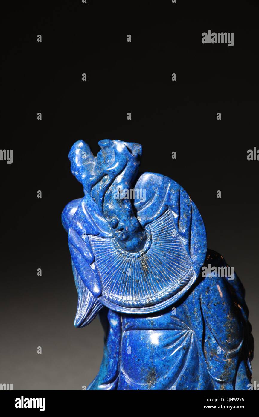 A vertical shot of a traditional Chinese lapis lazuli sculpture with a ...
