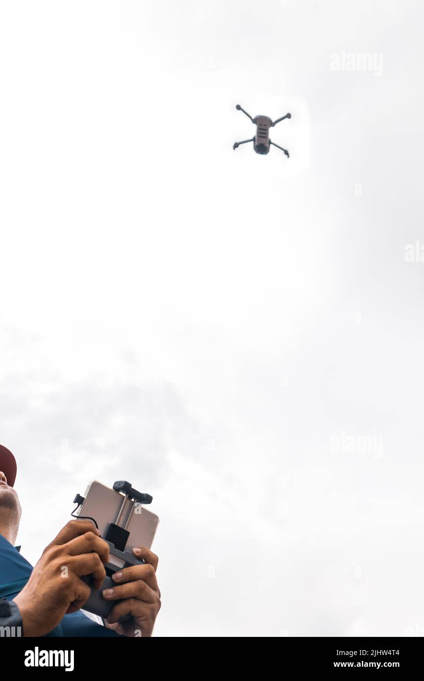 Vertical photo of an unrecognizable man taking off a drone Stock Photo ...