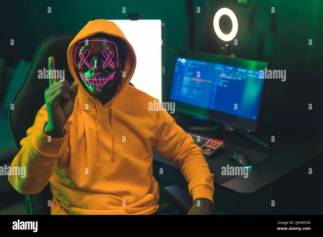 Black man wearing a dark mask with pink patterns covering his face ...