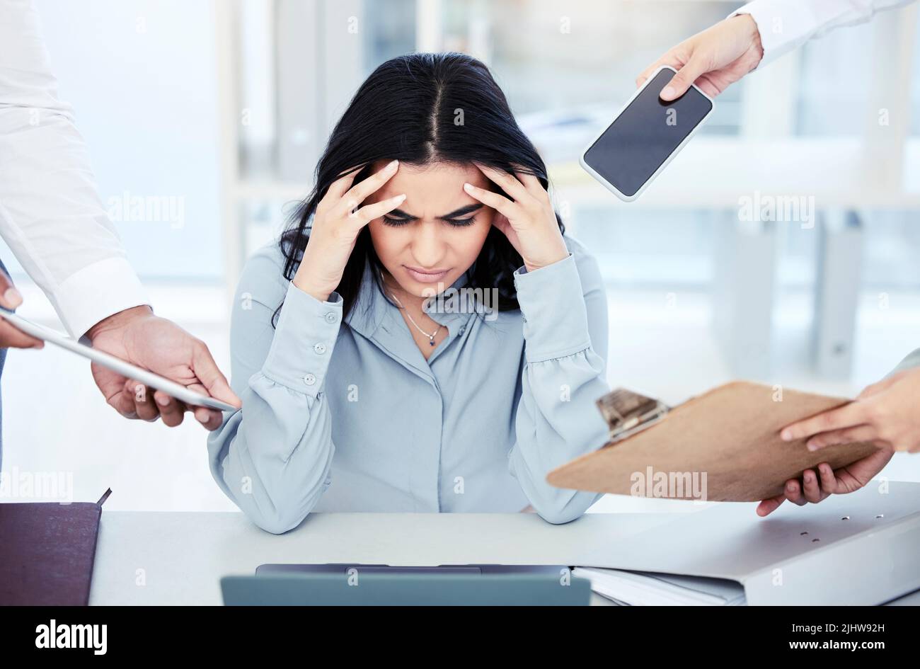 The pressure is on with too much to do. a young businesswoman looking ...