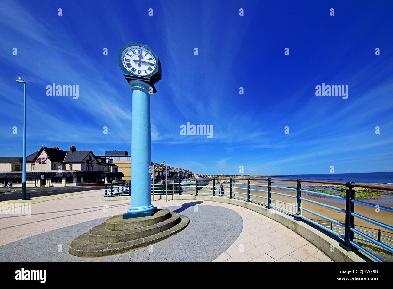 Whitley Bay promenade on a sunny day and the large blue clock with the ...