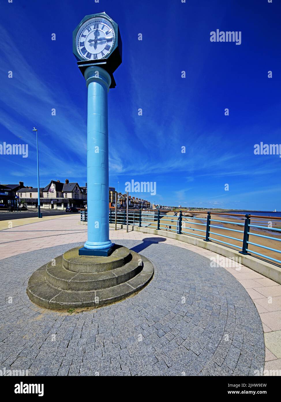 Whitley Bay promenade on a sunny day and the large blue clock with the ...
