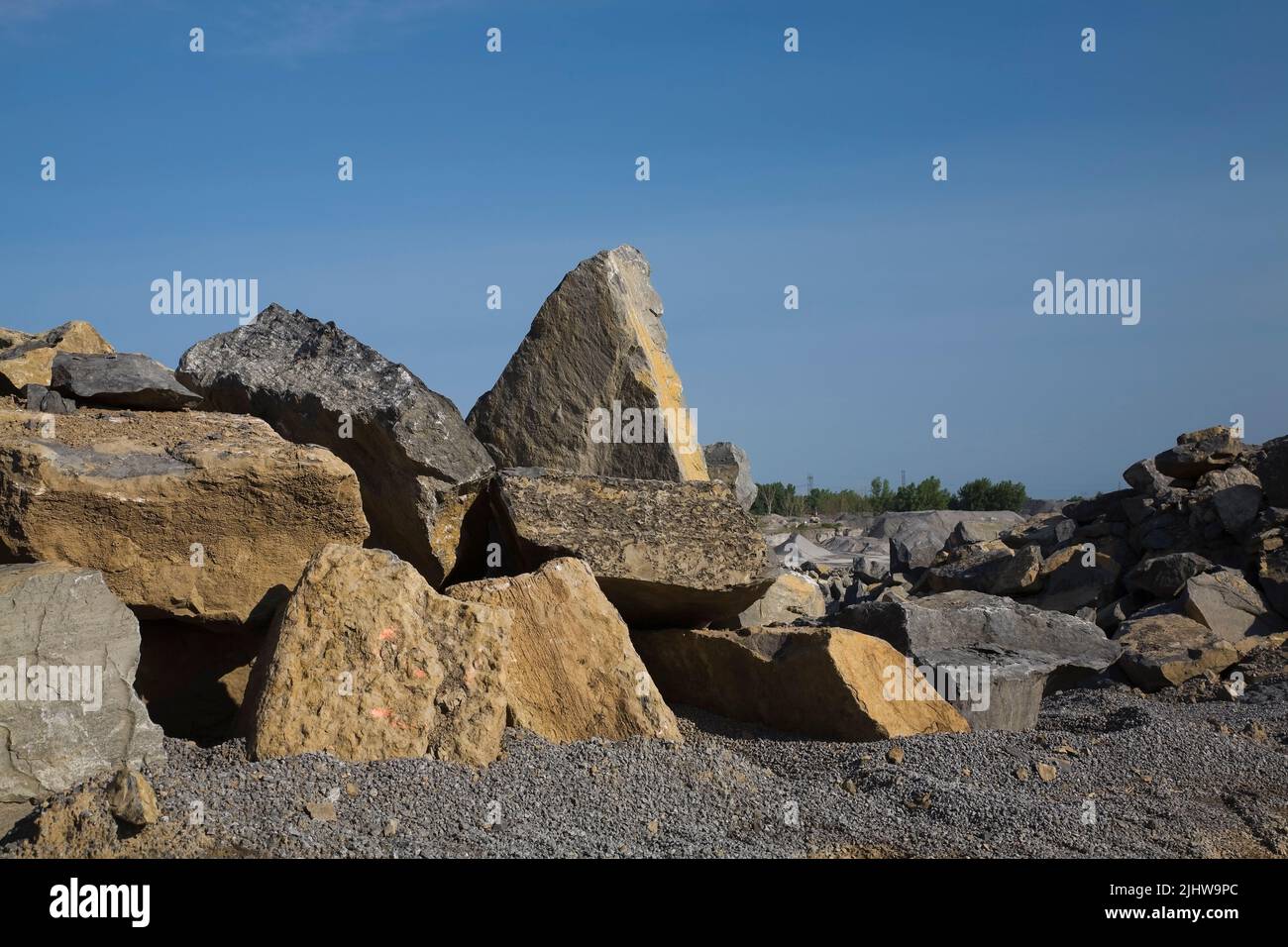 Pile of large cut rocks in commercial rock quarry Stock Photo - Alamy