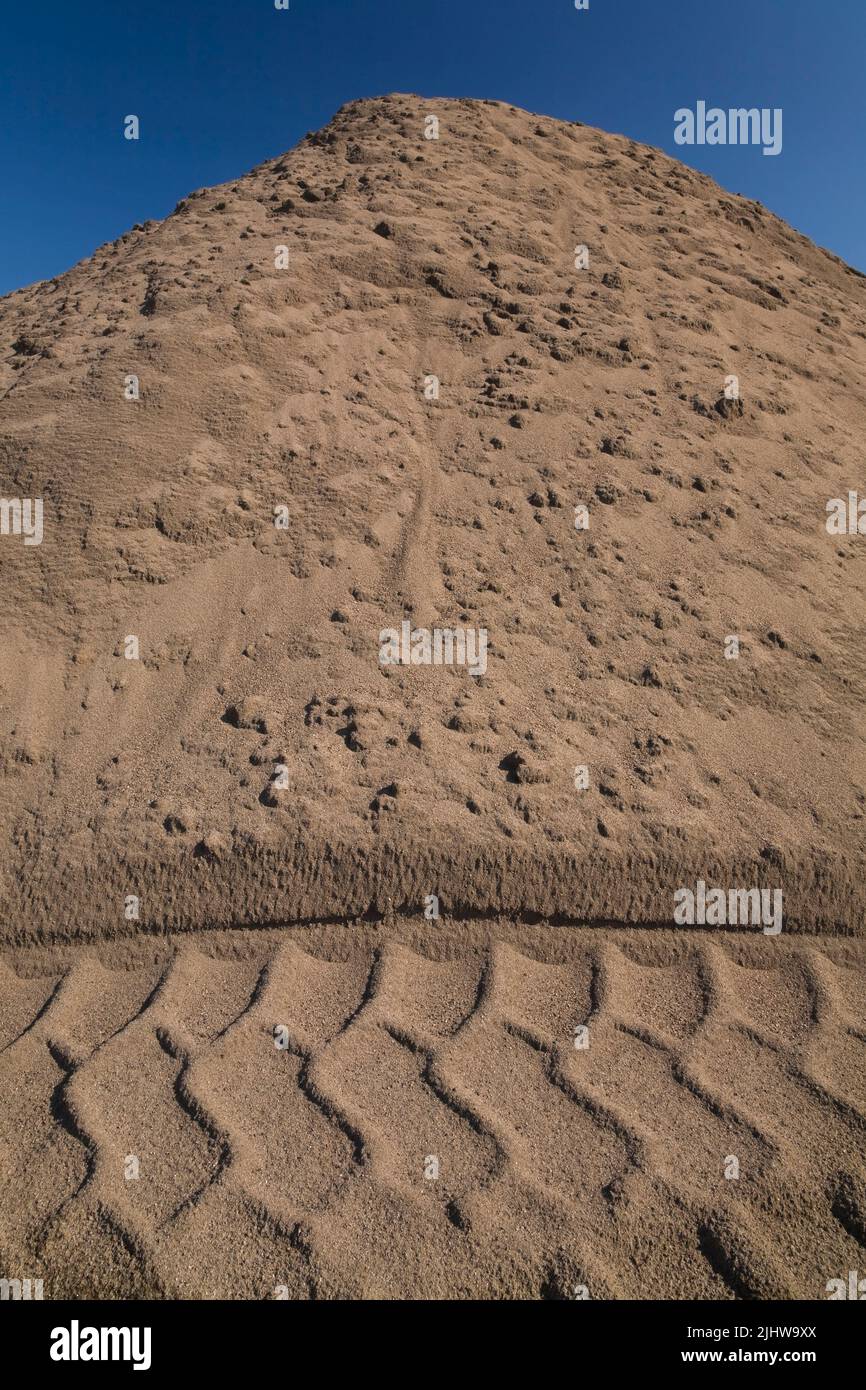 Tire track and mound of excavated fine sand in commercial sand pit ...