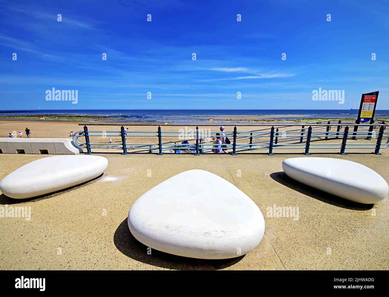 Whitley Bay promenade on a sunny day by the beach with three larges ...