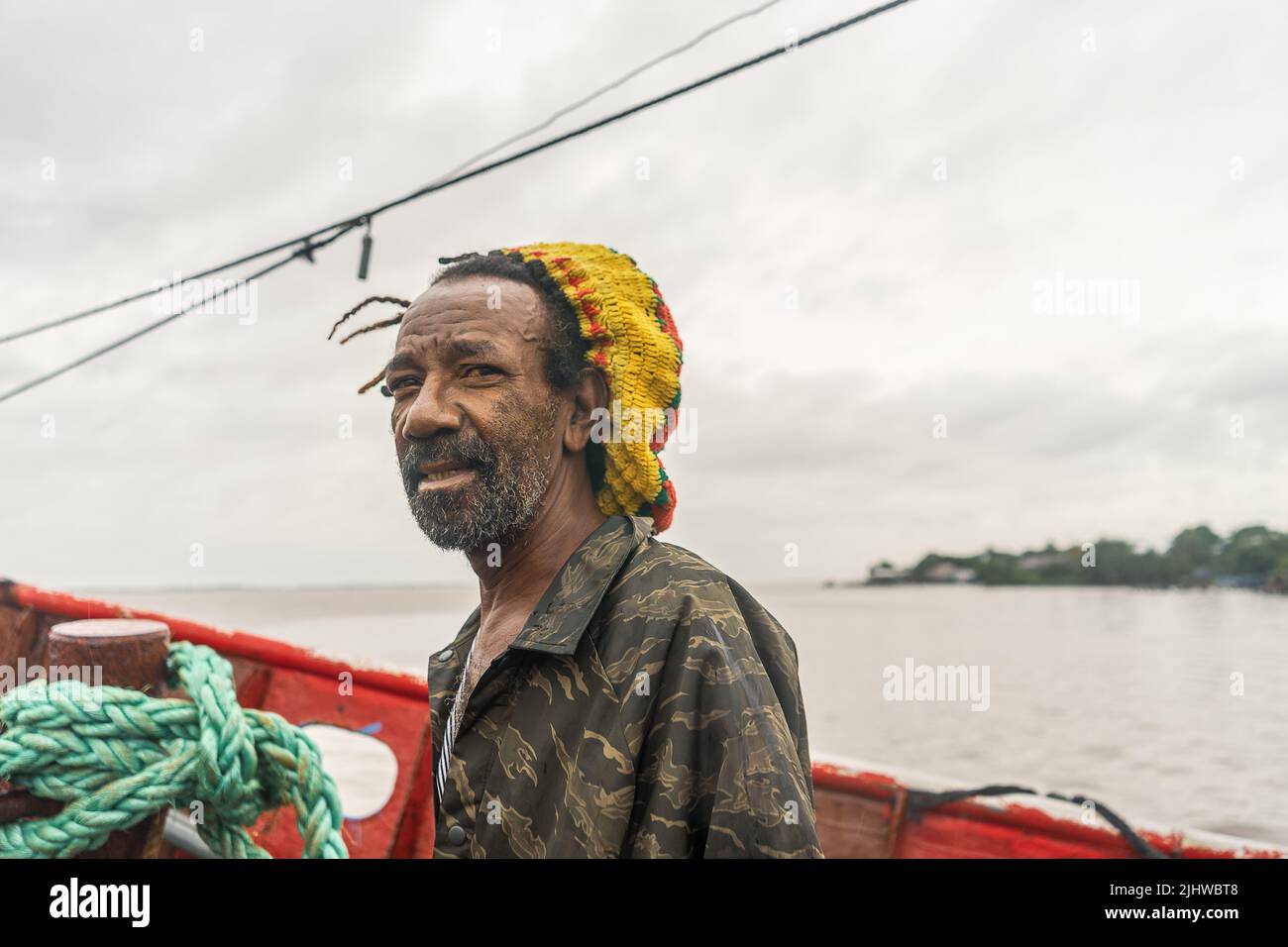 Black fisherman in the Caribbean of Nicaragua riding a boat and looking ...