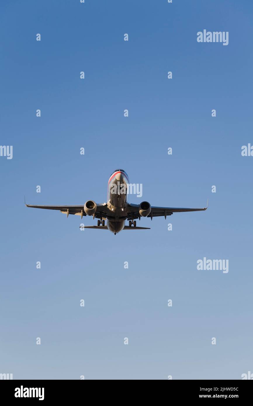Commercial jet airplane landing Stock Photo - Alamy