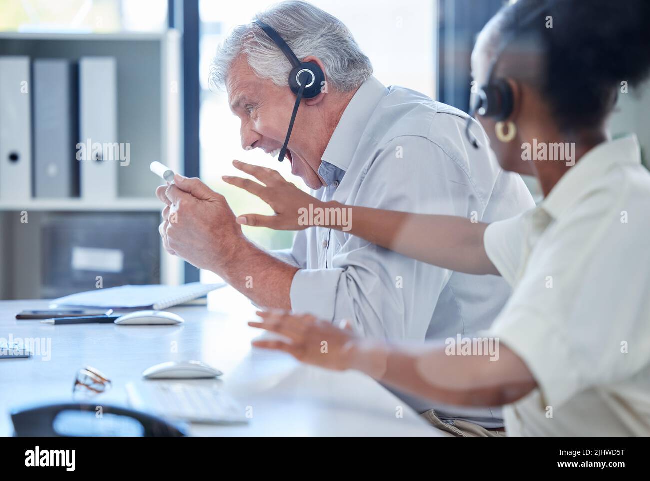 When rage takes over. a mature call centre agent getting angry and ...